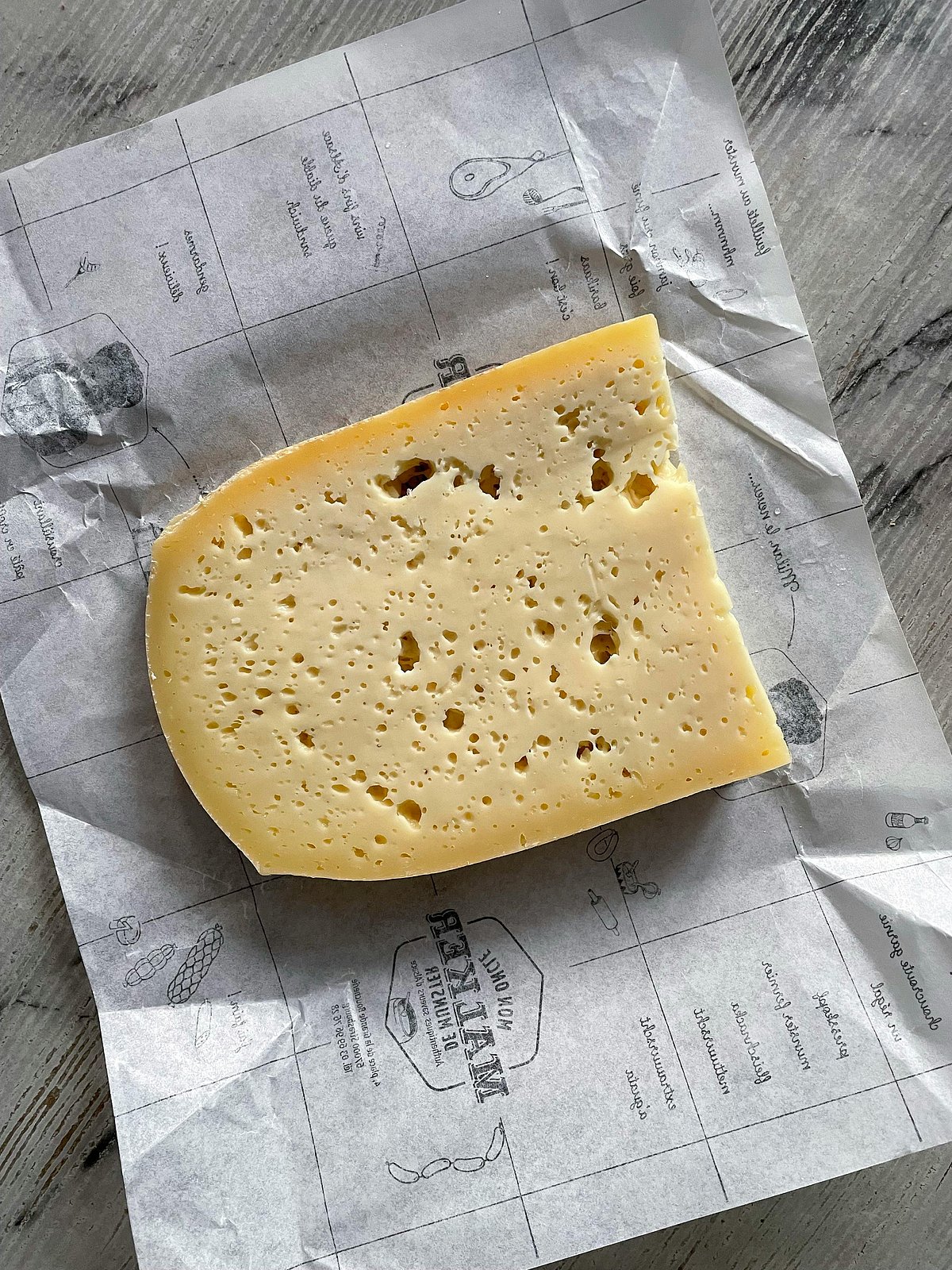 Why do some cheese have holes and how are they formed?